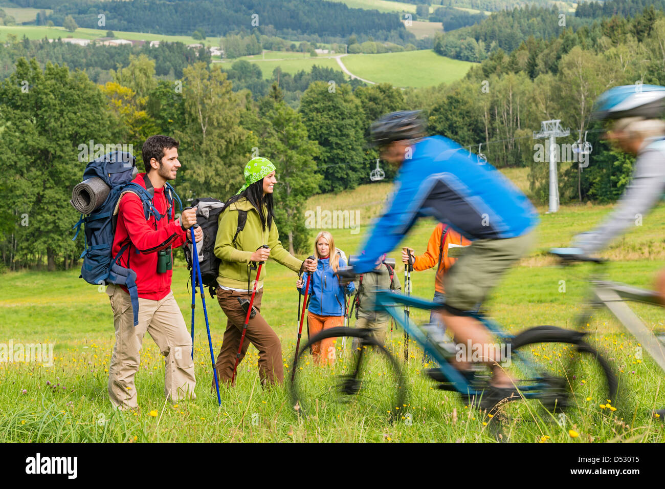 People hiking and riding bikes on summer vacation nature landscape ...