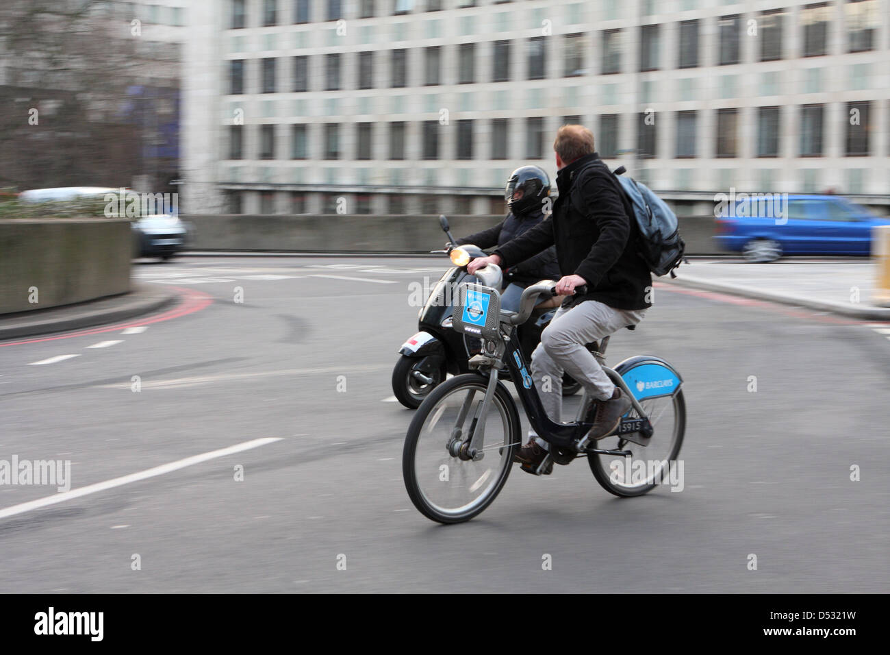 cyclist and motor bike entering a roundabout in London, England Stock ...