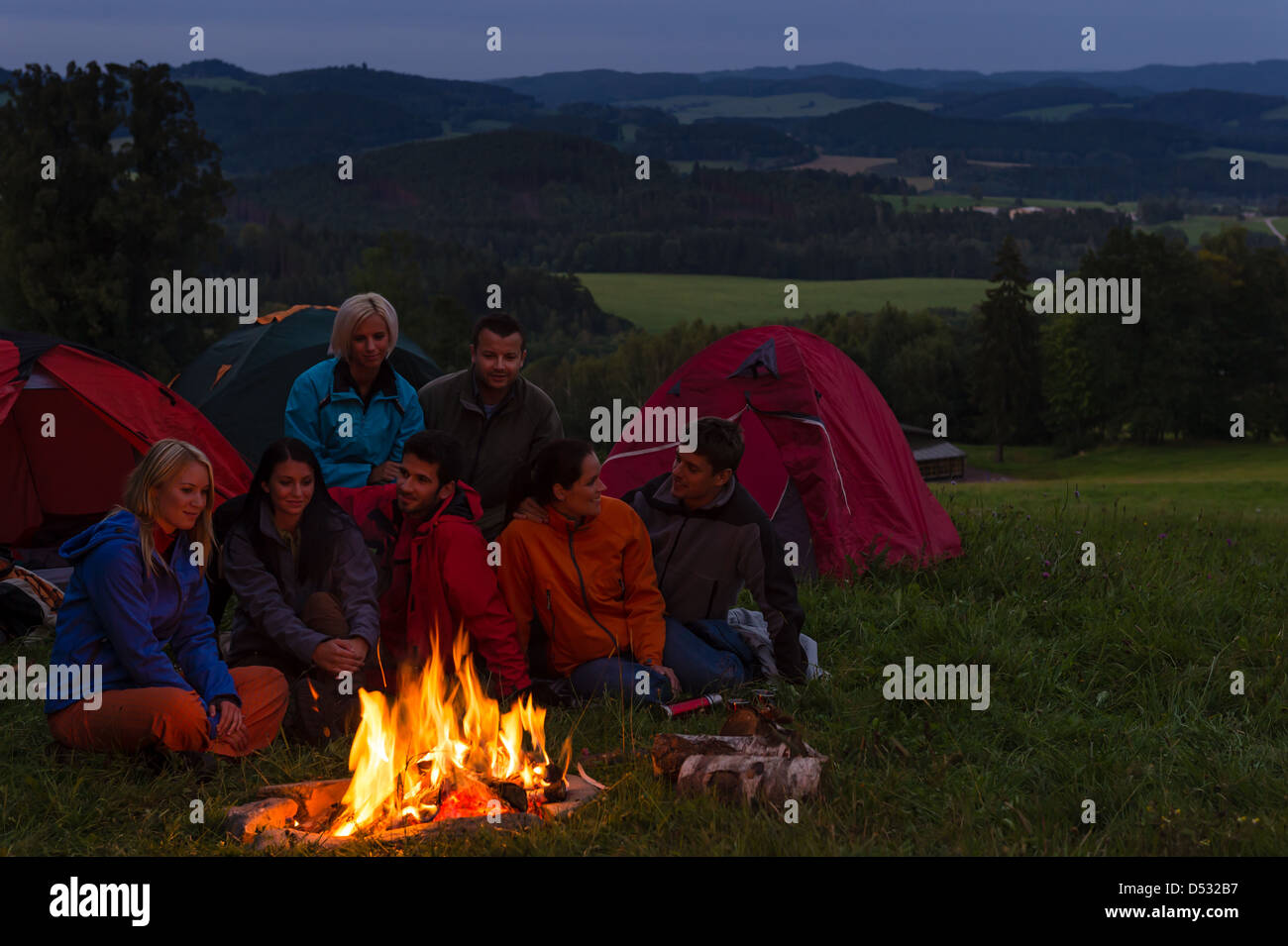 During night camping friends setting fire beside tents Stock Photo - Alamy