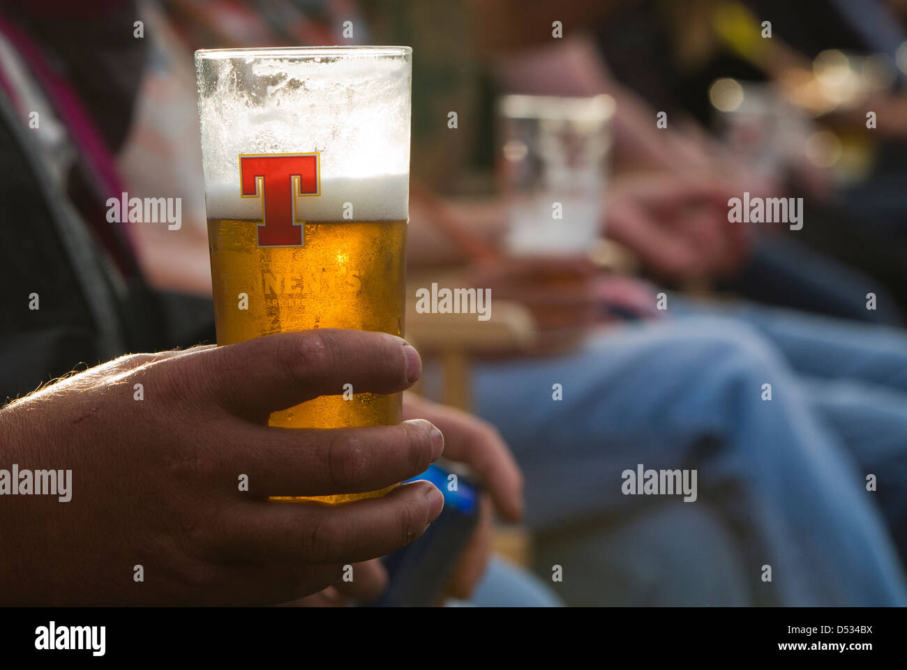 People drinking pints of larger beer Stock Photo - Alamy