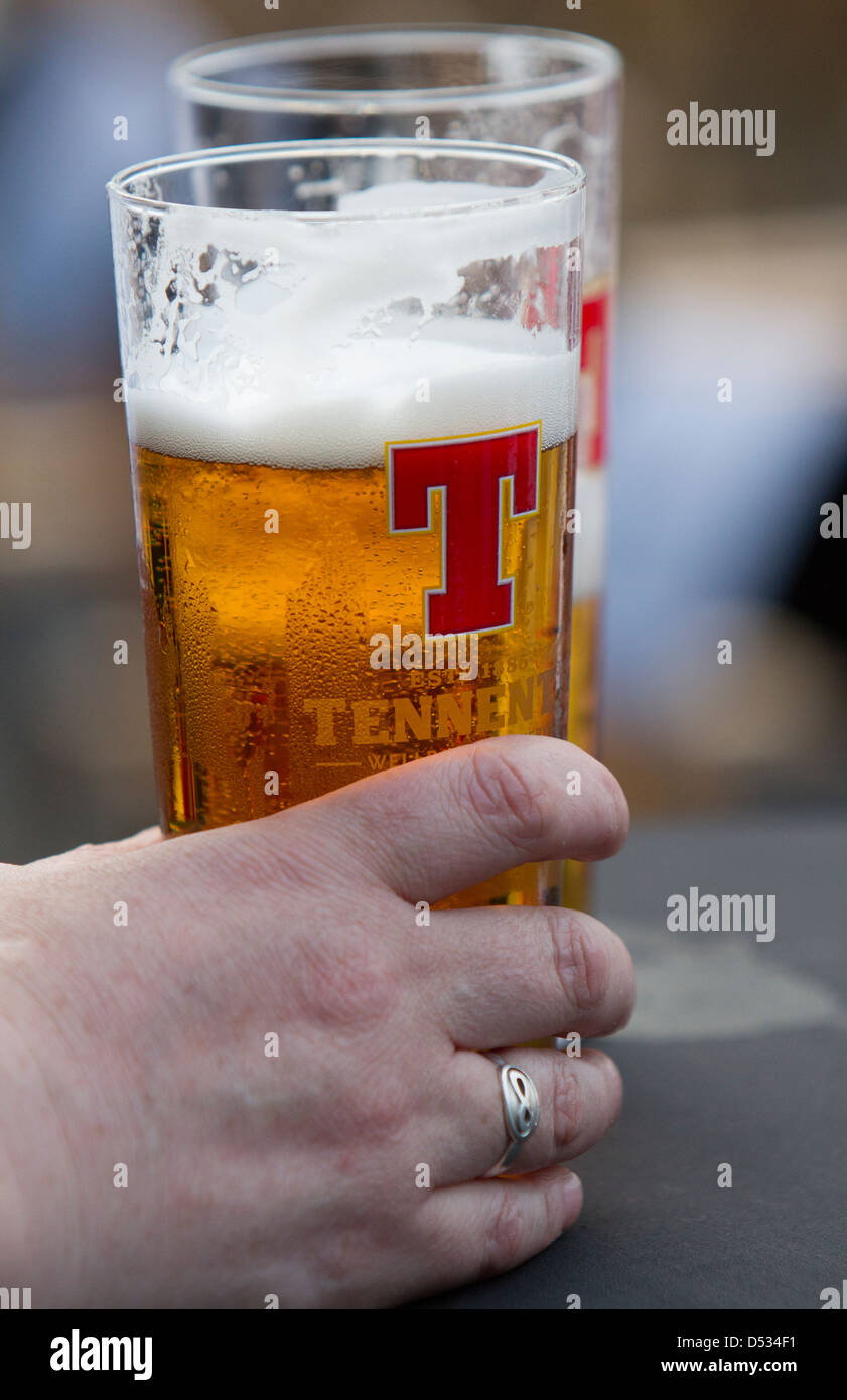 People drinking pints of larger beer Stock Photo - Alamy