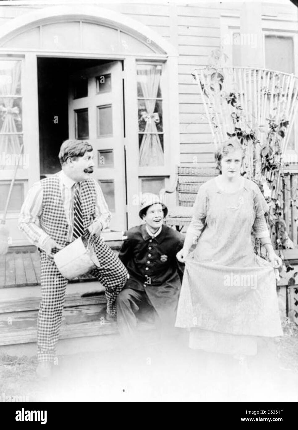 A 1916 motion picture scene featuring Ethel Burton and other actors ...
