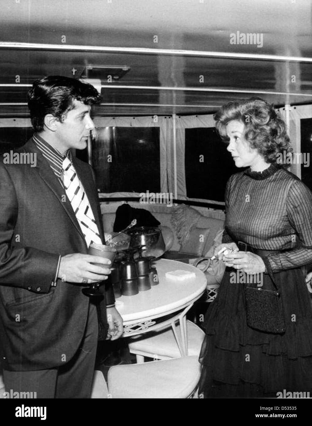 In this photo, actress Susan Hayward is seen chatting with an ...