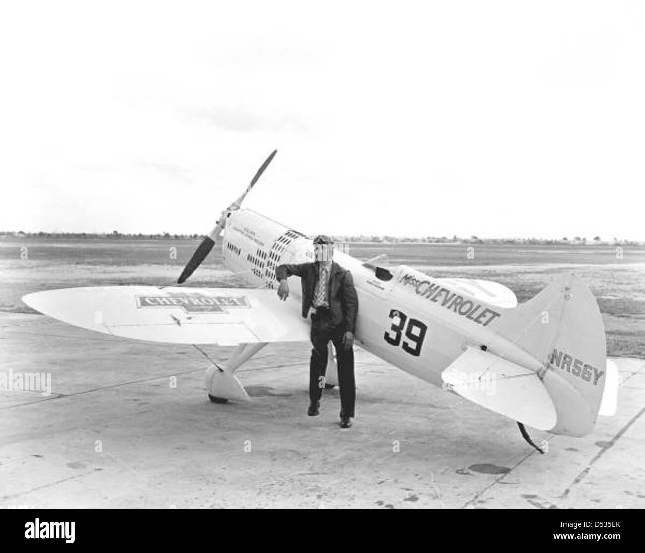Harold Neumann poses with Miss Chevrolet at an air racing event in ...