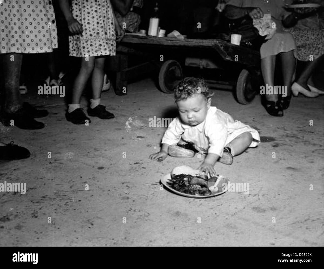 An 8-month-old Mary Odum is seen eating off the floor during a barbecue ...