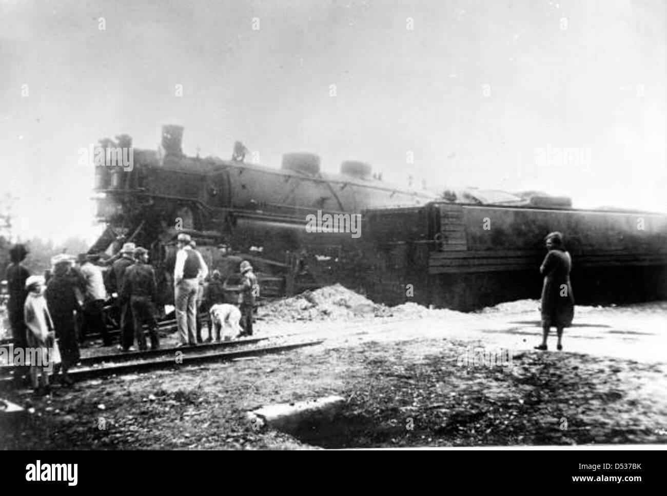 A group of people stand near a train wreck in Lloyd, Florida. The image ...