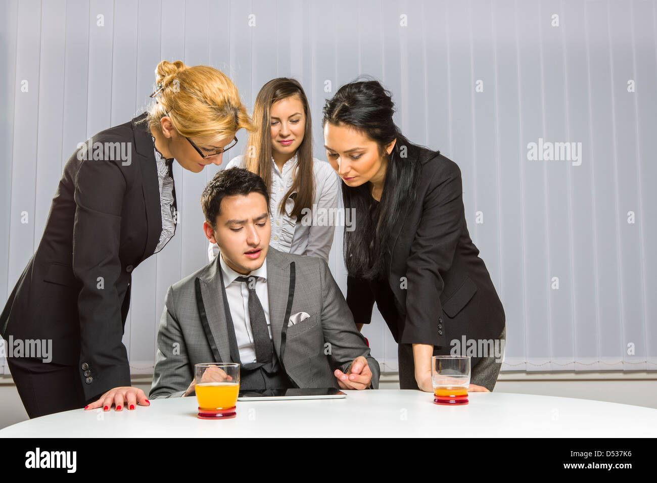Four business partners discussing and planning together during a ...