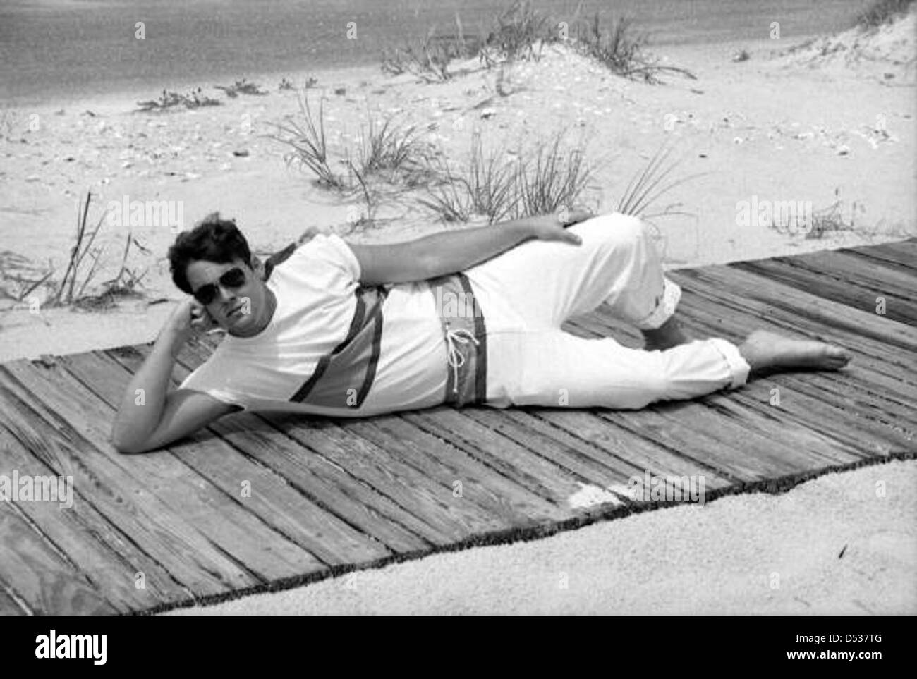 Fashion model Deborah Thomas poses on a beach boardwalk, captured in a ...
