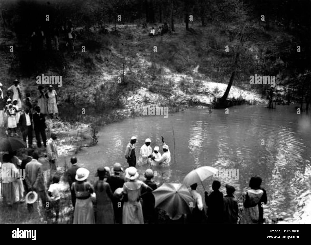This image shows African American citizens participating in a baptism ...