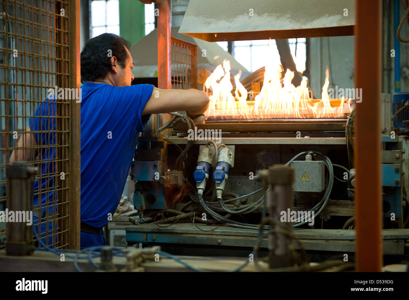 Berlin, Germany, employee controls the casting process of the lead grid ...