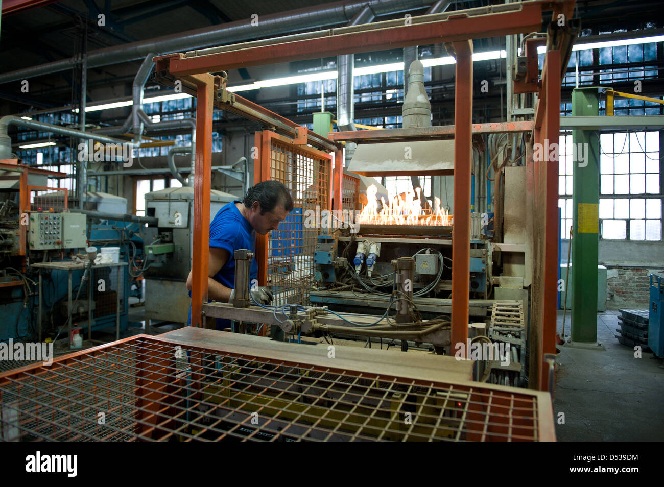Berlin, Germany, employee controls the casting process of the lead grid ...