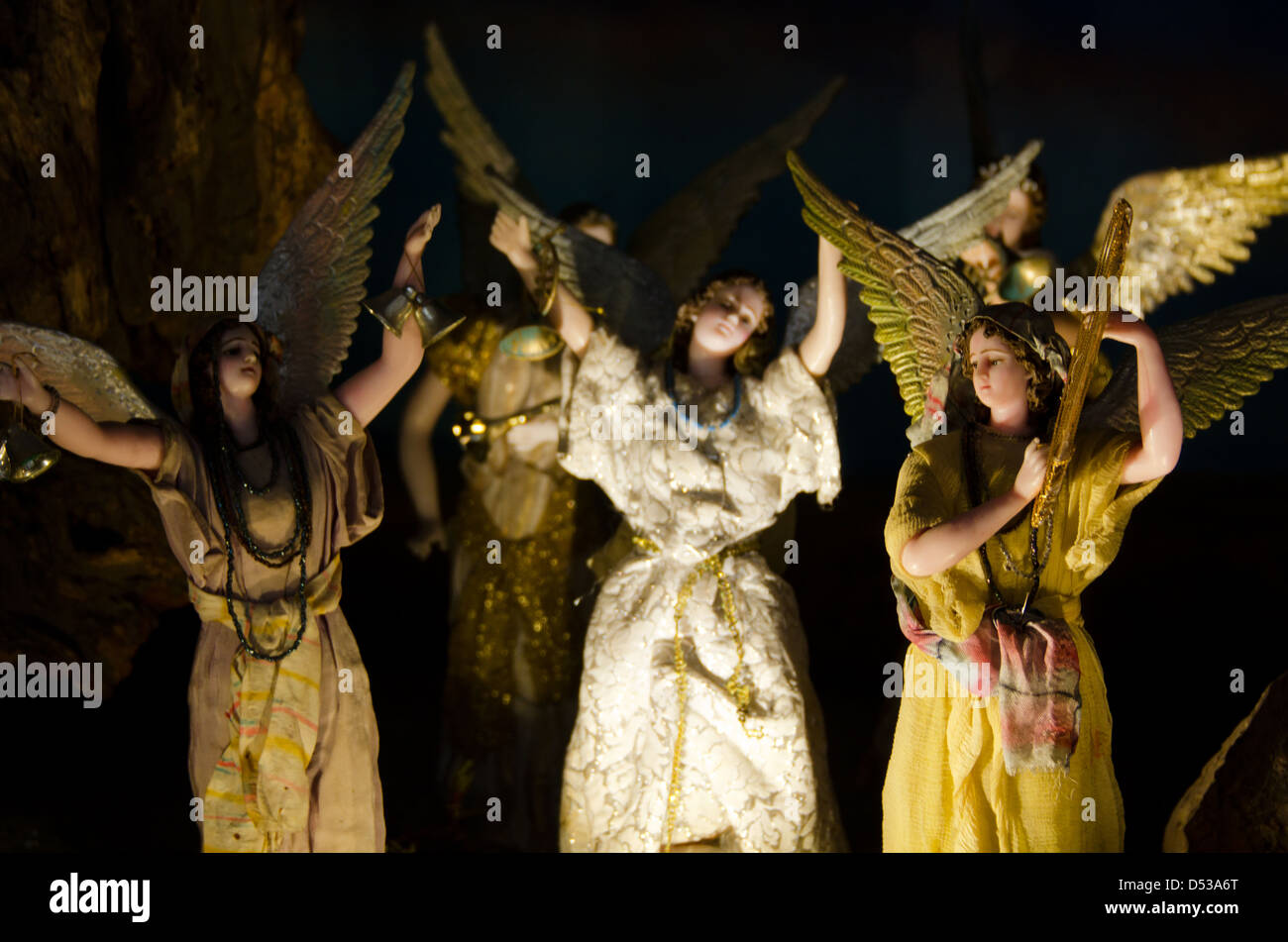 Three angels in a nativity scene dancing and playing the harp. From the ...