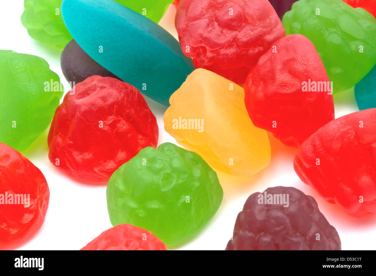 Colorful fruits candy closeup on white background Stock Photo - Alamy