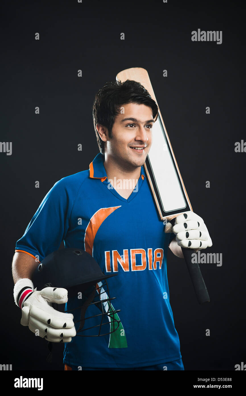 Batsman holding a cricket bat with sports helmet and smiling Stock ...