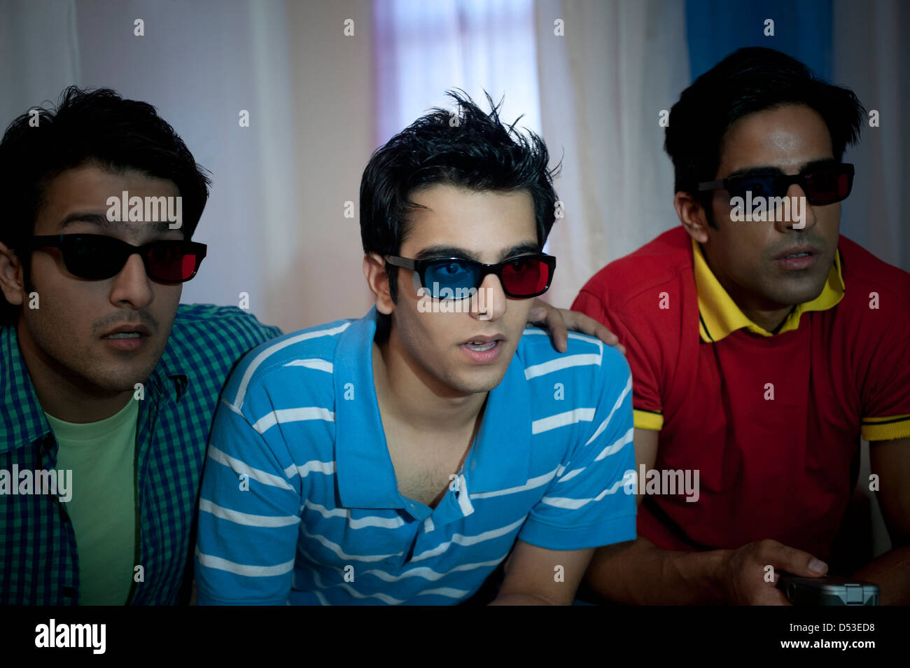 Three surprised friends watching hi-res stock photography and images ...