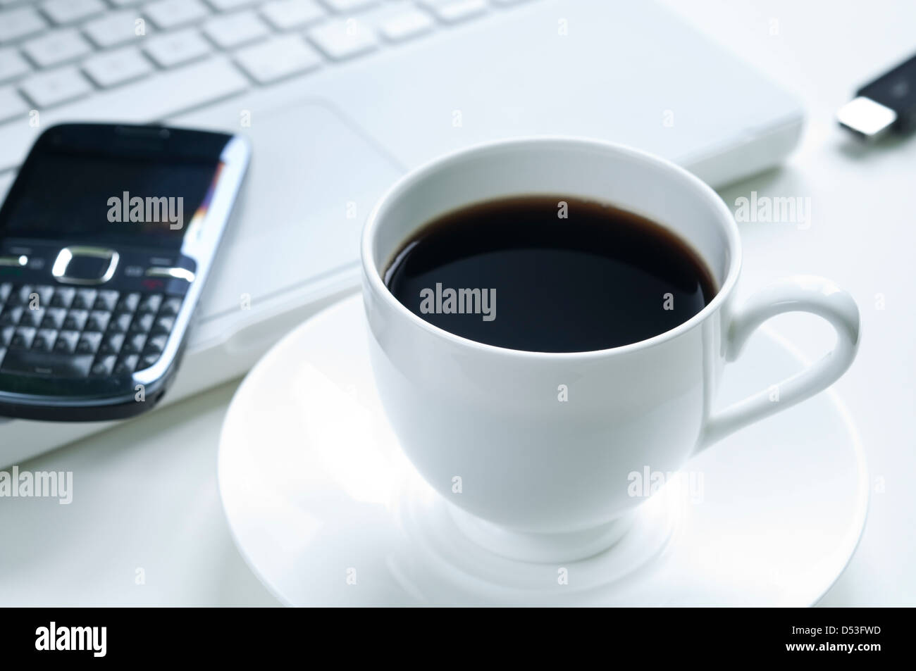 Modern laptop with mobile phone and cup of coffee Stock Photo - Alamy