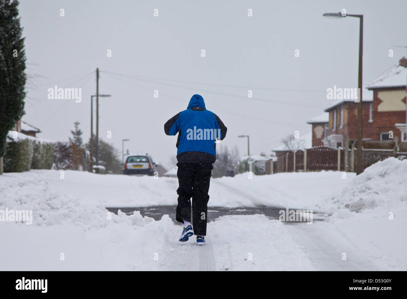 Rotherham, UK. 23rd March 2013. Trudging on. a young man wearing ...