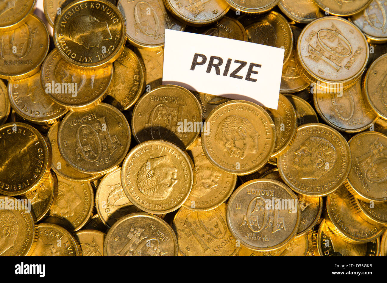 Stack of golden coins with a sign showing Prize Stock Photo - Alamy