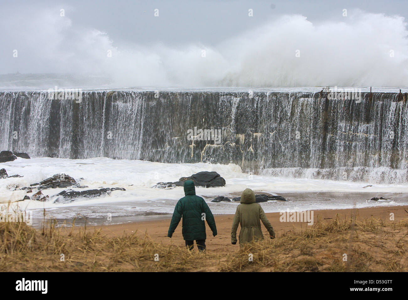 Storm gazers admire the power of the sea at Aberdeen breakwater Stock ...