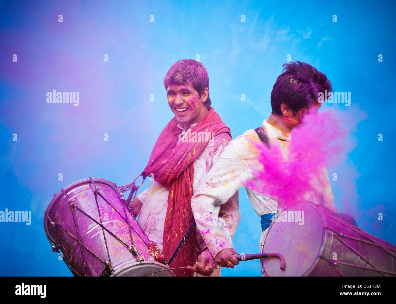 Two friends celebrating Holi with playing dhol Stock Photo - Alamy