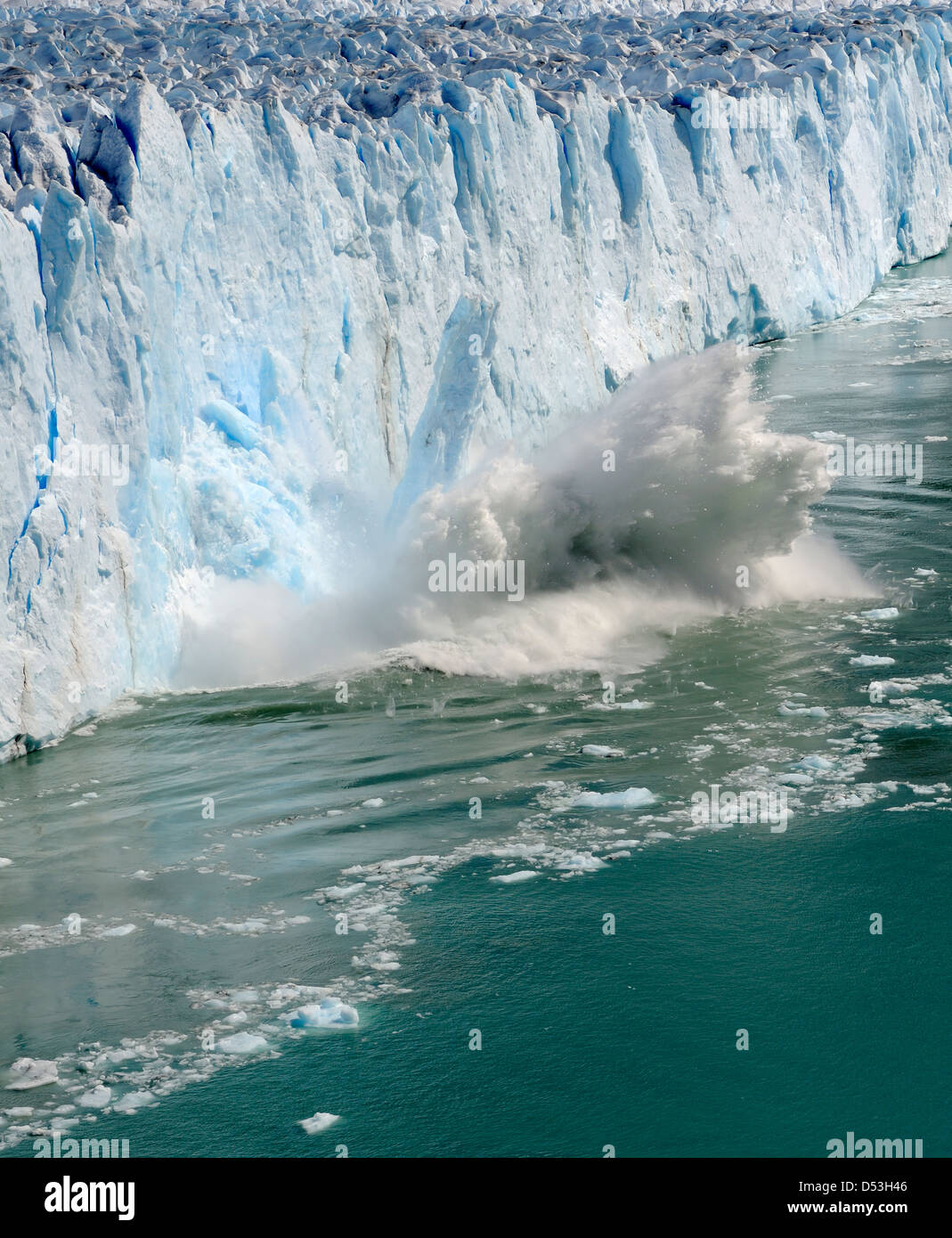 A tower of ice collapses from the face of the Perito Moreno Glacier ...