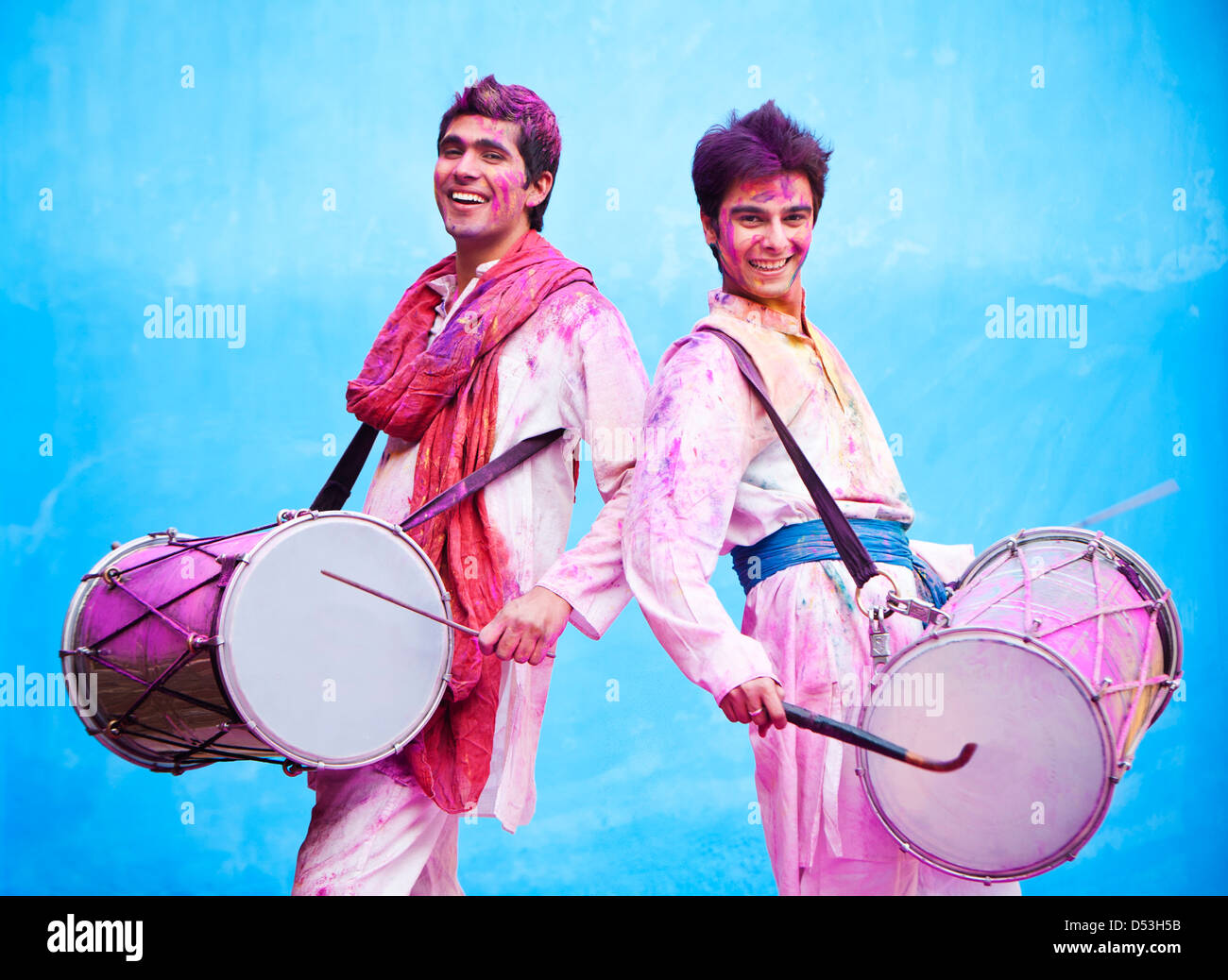 Portrait of two friends celebrating Holi with playing dhol Stock Photo ...