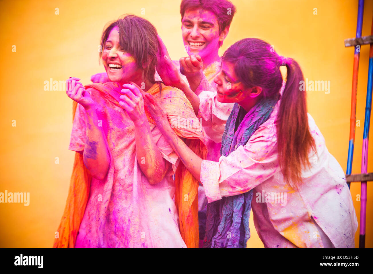 Friends celebrating Holi Stock Photo - Alamy