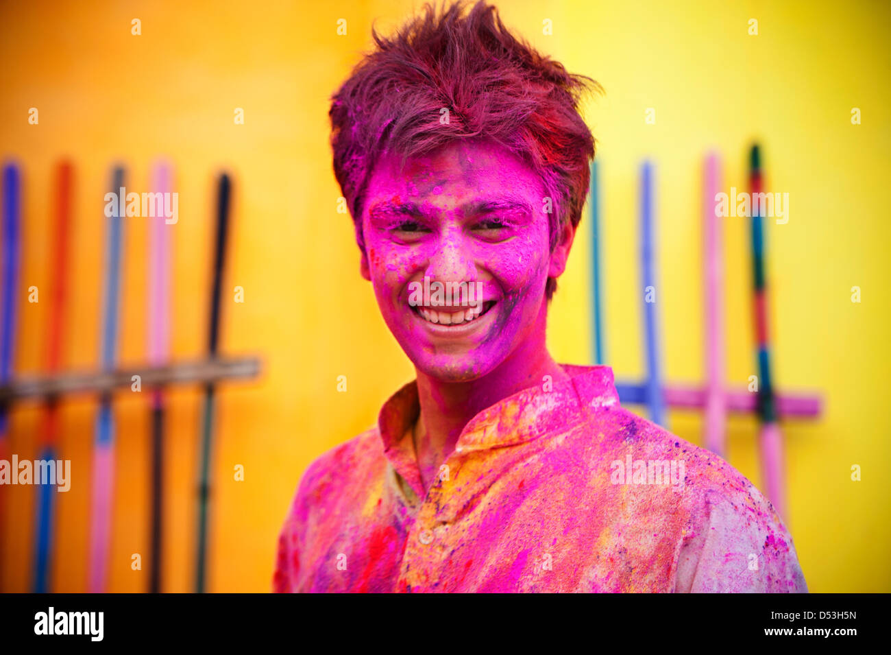 Smiling man with his face smeared with colors Stock Photo - Alamy