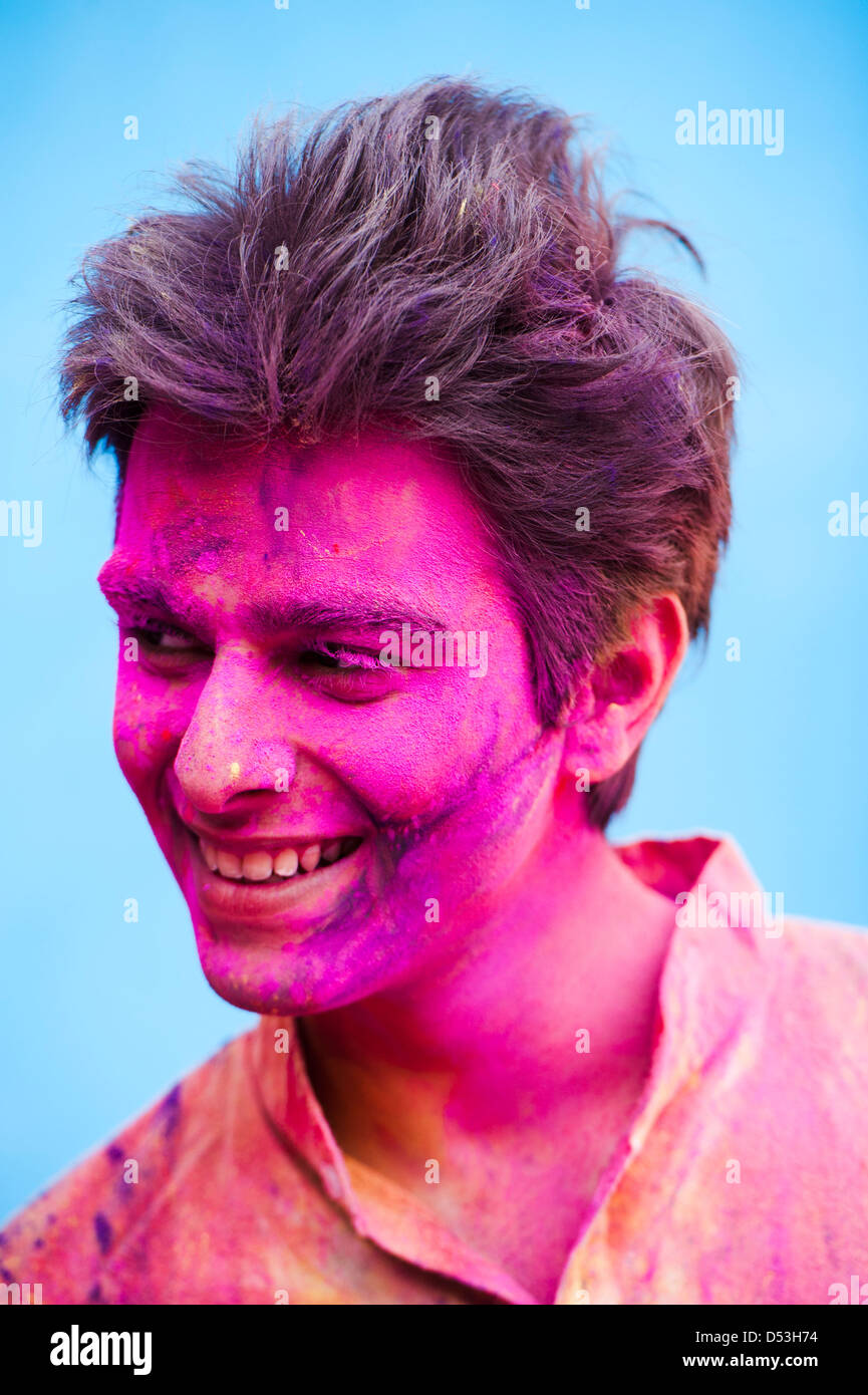 Smiling man with his face smeared with colors Stock Photo - Alamy
