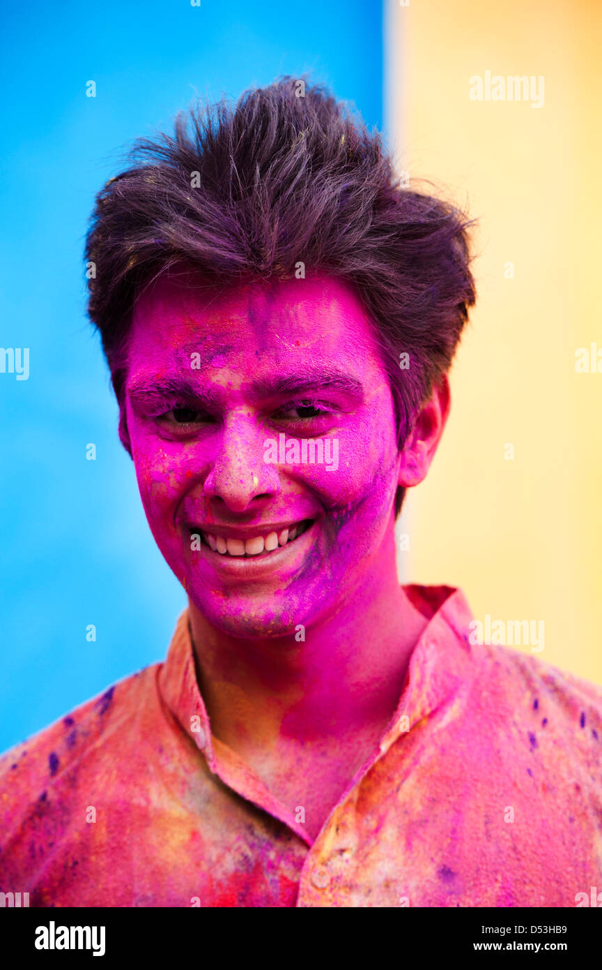 Smiling man with his face smeared with colors Stock Photo - Alamy
