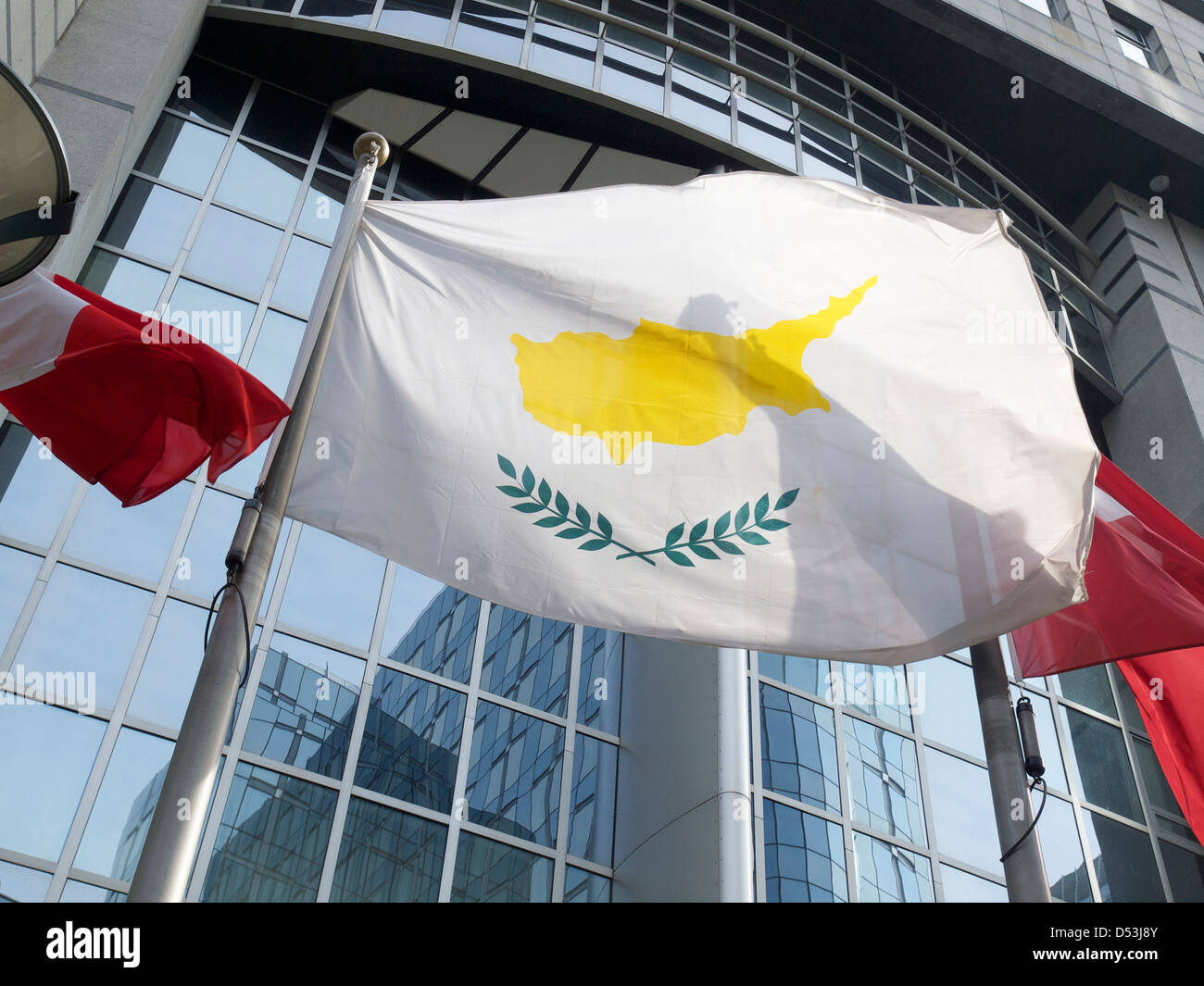 Flag of Cyprus waving in front of the EU parliament building in ...