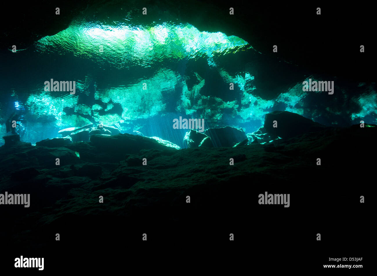 Cenote cave, rock formation underwater with ambient light and ...