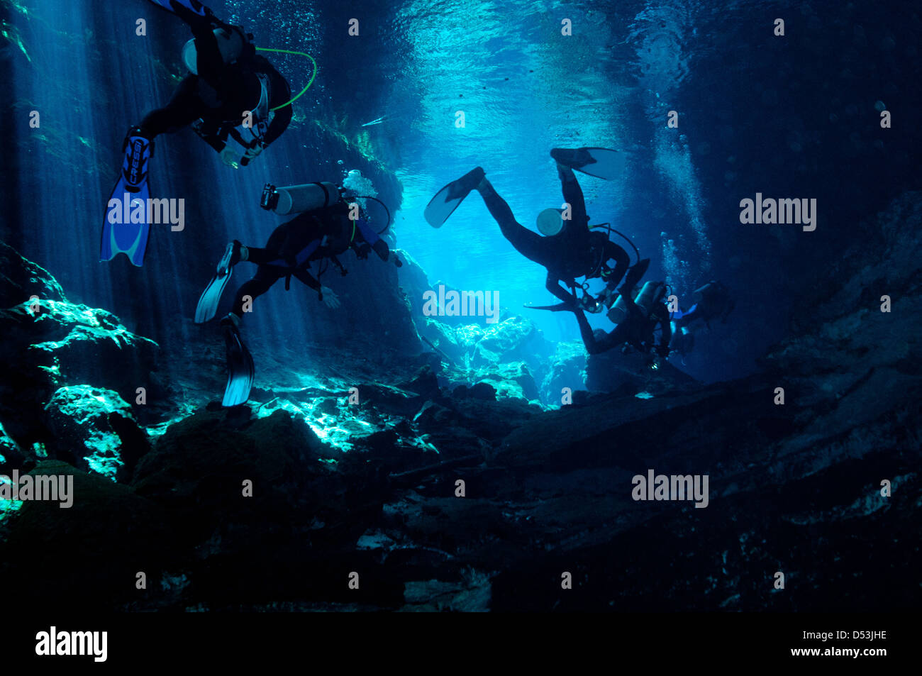 Cenote cave, rock formation underwater with ambient light and ...