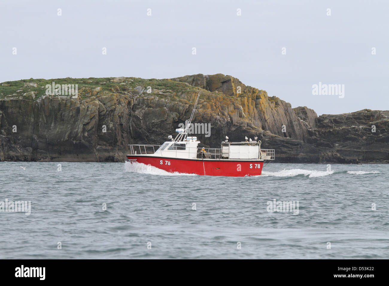 A lobster fishing boat off the rocky coast of Cape Clear Island Ireland ... A lobster fishing boat off the rocky coast of Cape Clear Island Ireland ...