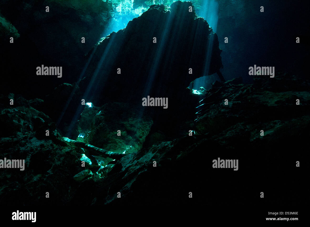 Cenote cave, rock formation underwater with ambient light and ...