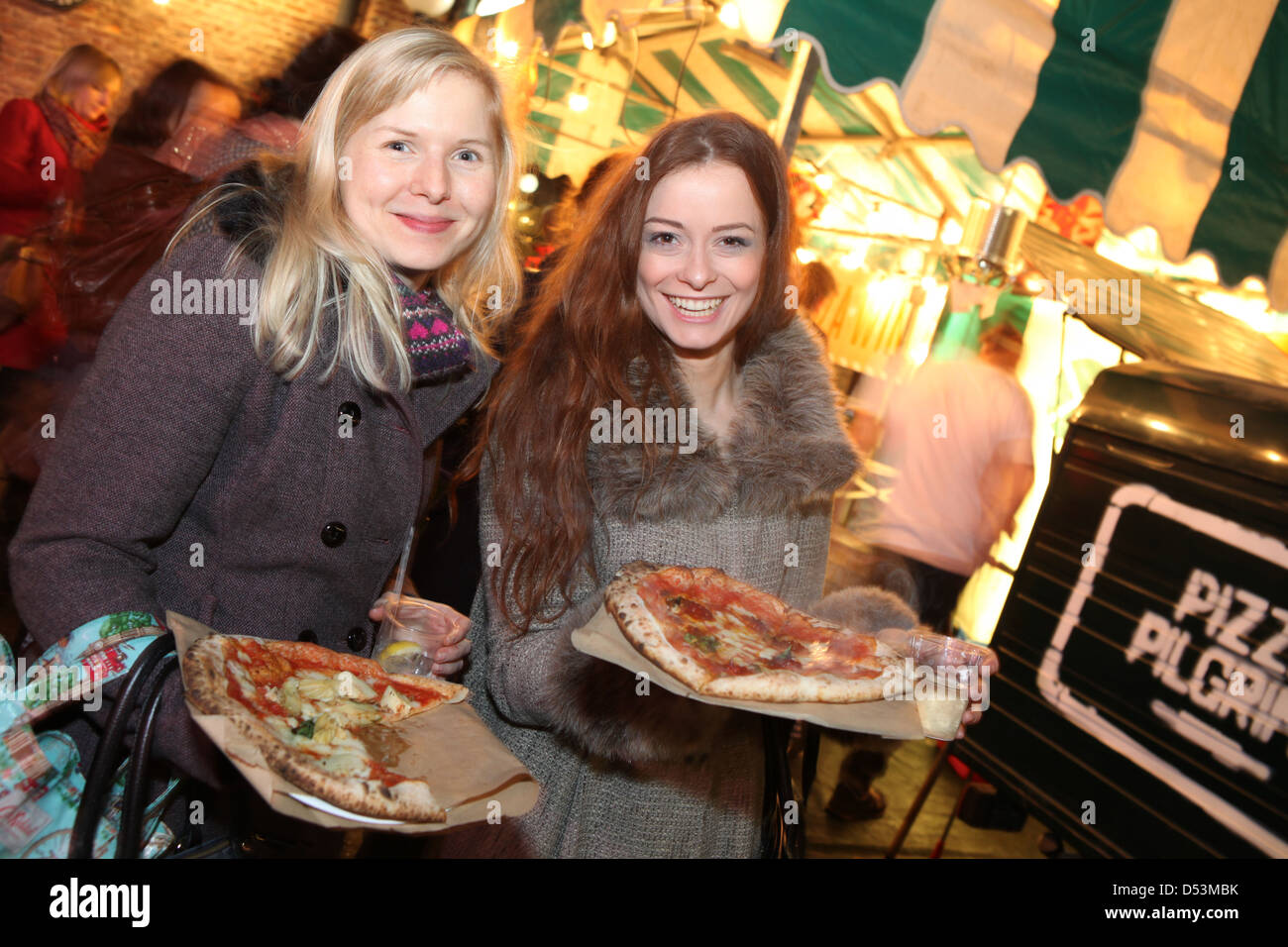 people eating food at Feast food festival at Tobacco Dock, London UK ...