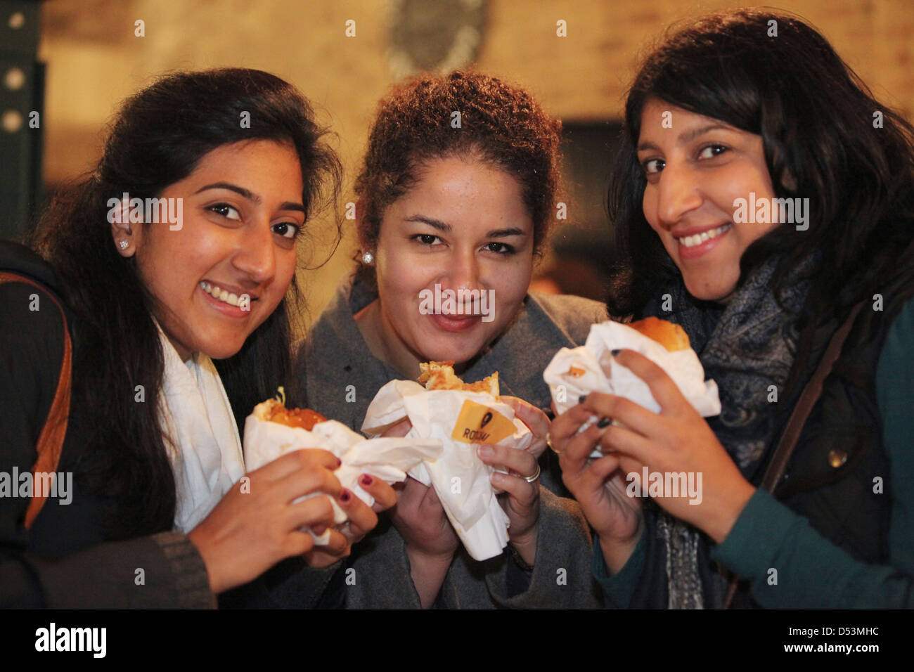 people eating food at Feast food festival at Tobacco Dock, London UK ...