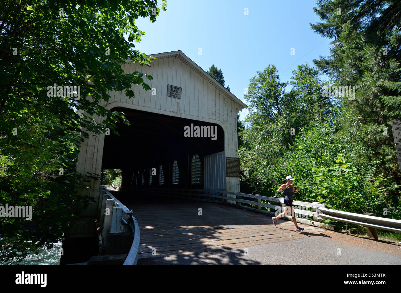 Runner emerging from Belknap Bridge, a covered bridge over Oregon's ...