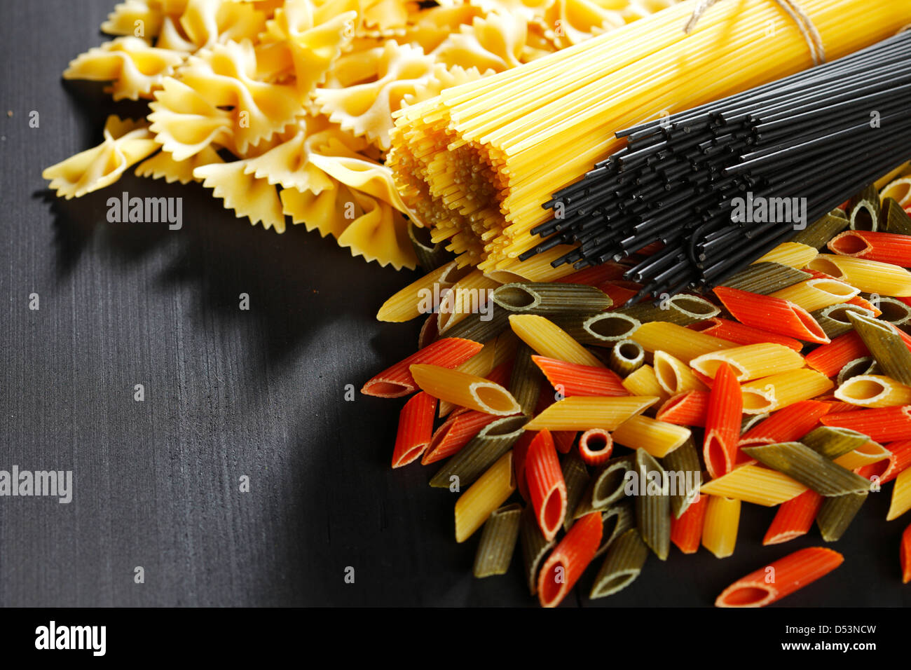 Variety of types and shapes of Italian pasta on black table Stock Photo ...