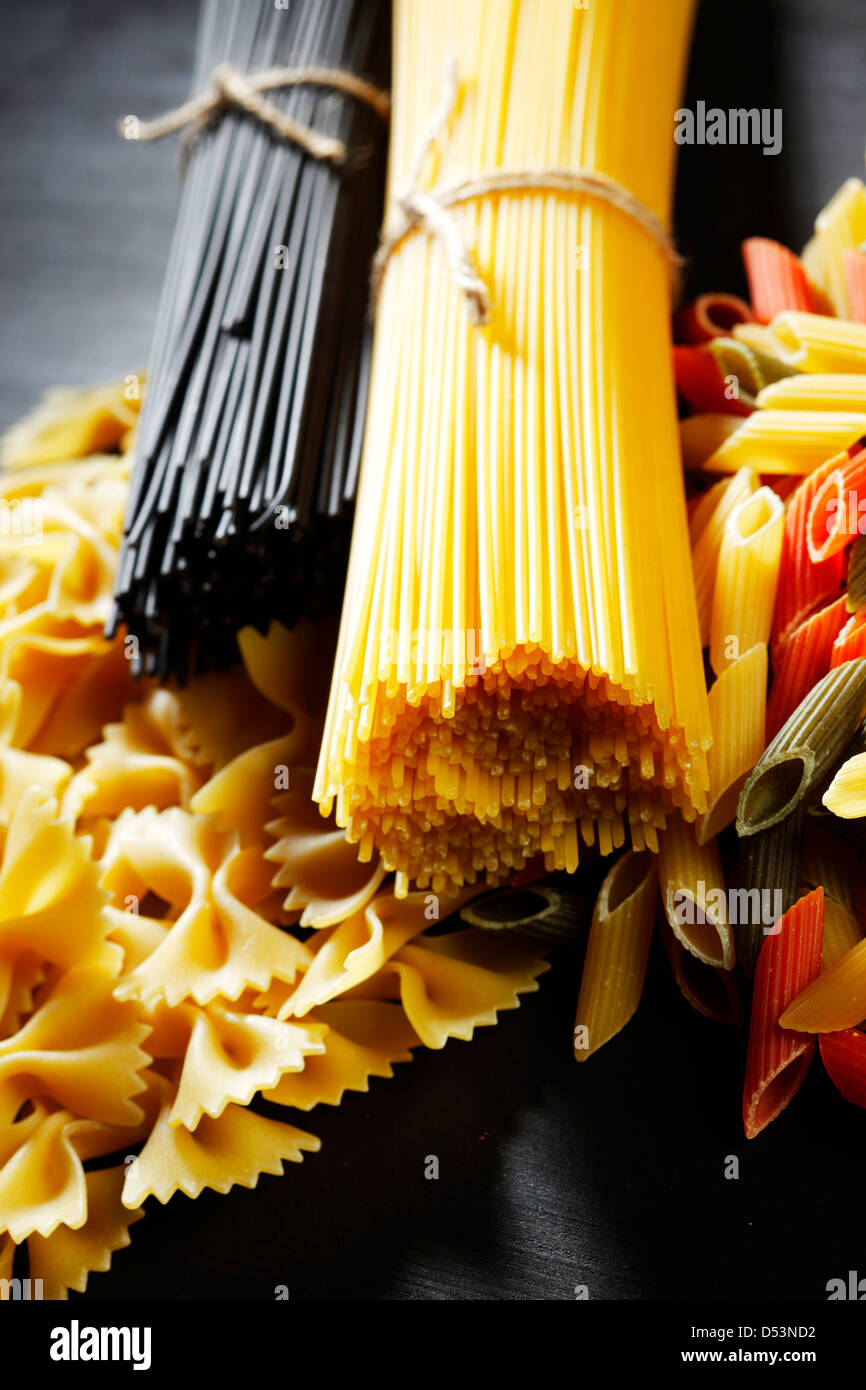 Variety of types and shapes of Italian pasta on black table Stock Photo ...