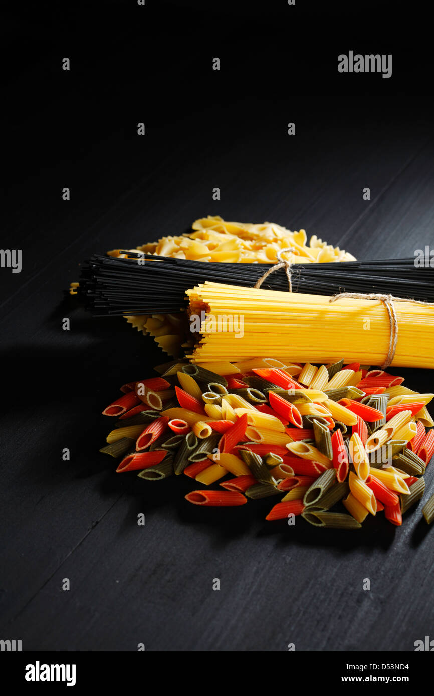 Variety of types and shapes of Italian pasta on black table Stock Photo ...