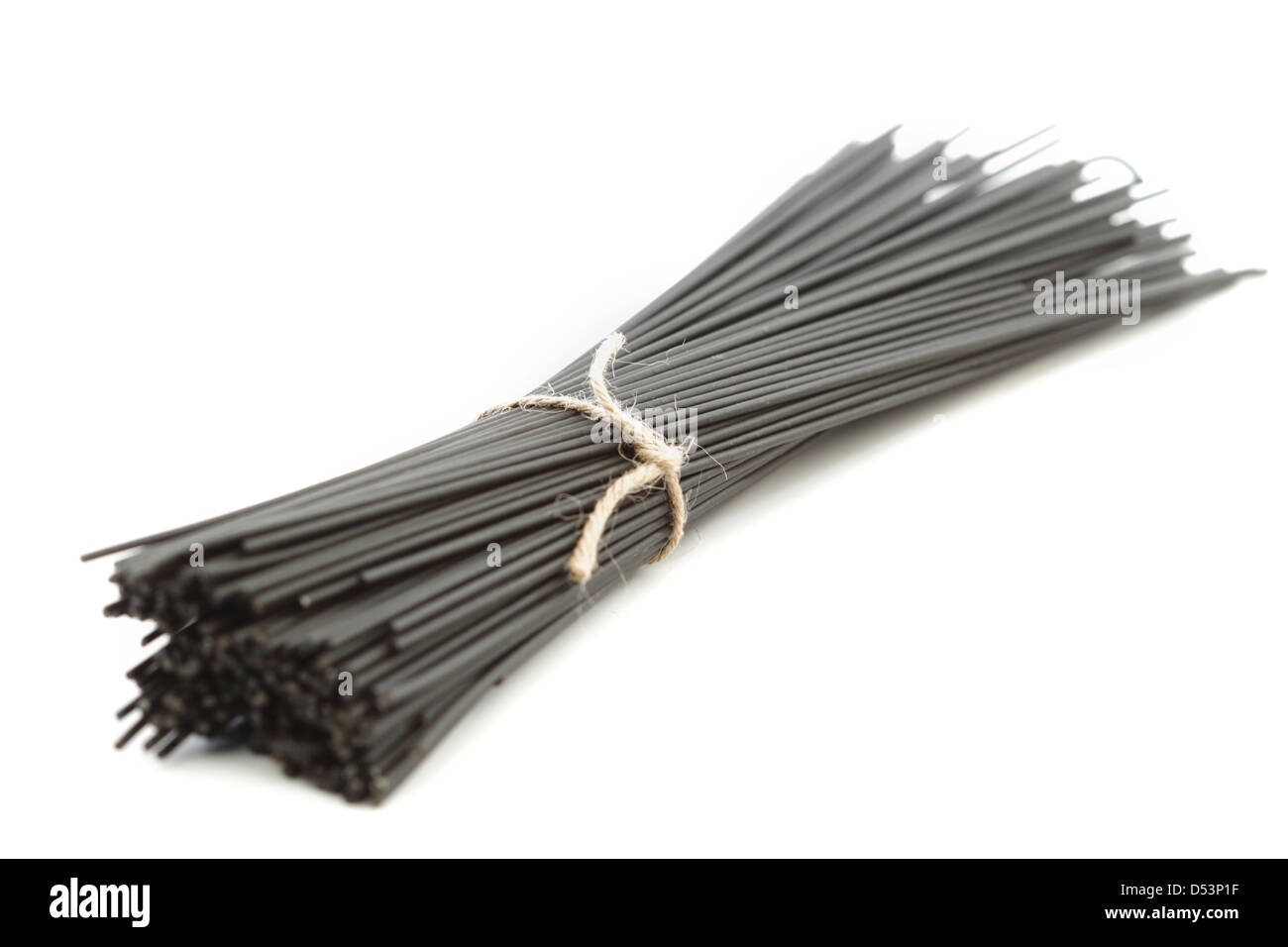 Black dry spaghetti isolated on white background Stock Photo - Alamy