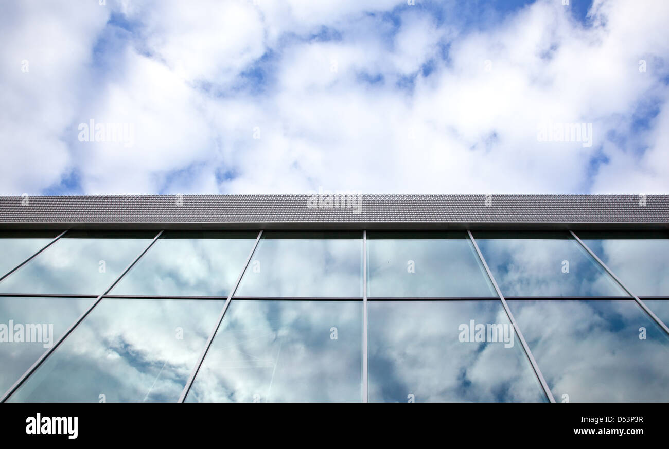 clouds and blue sky reflected in windows of office building Stock Photo ...