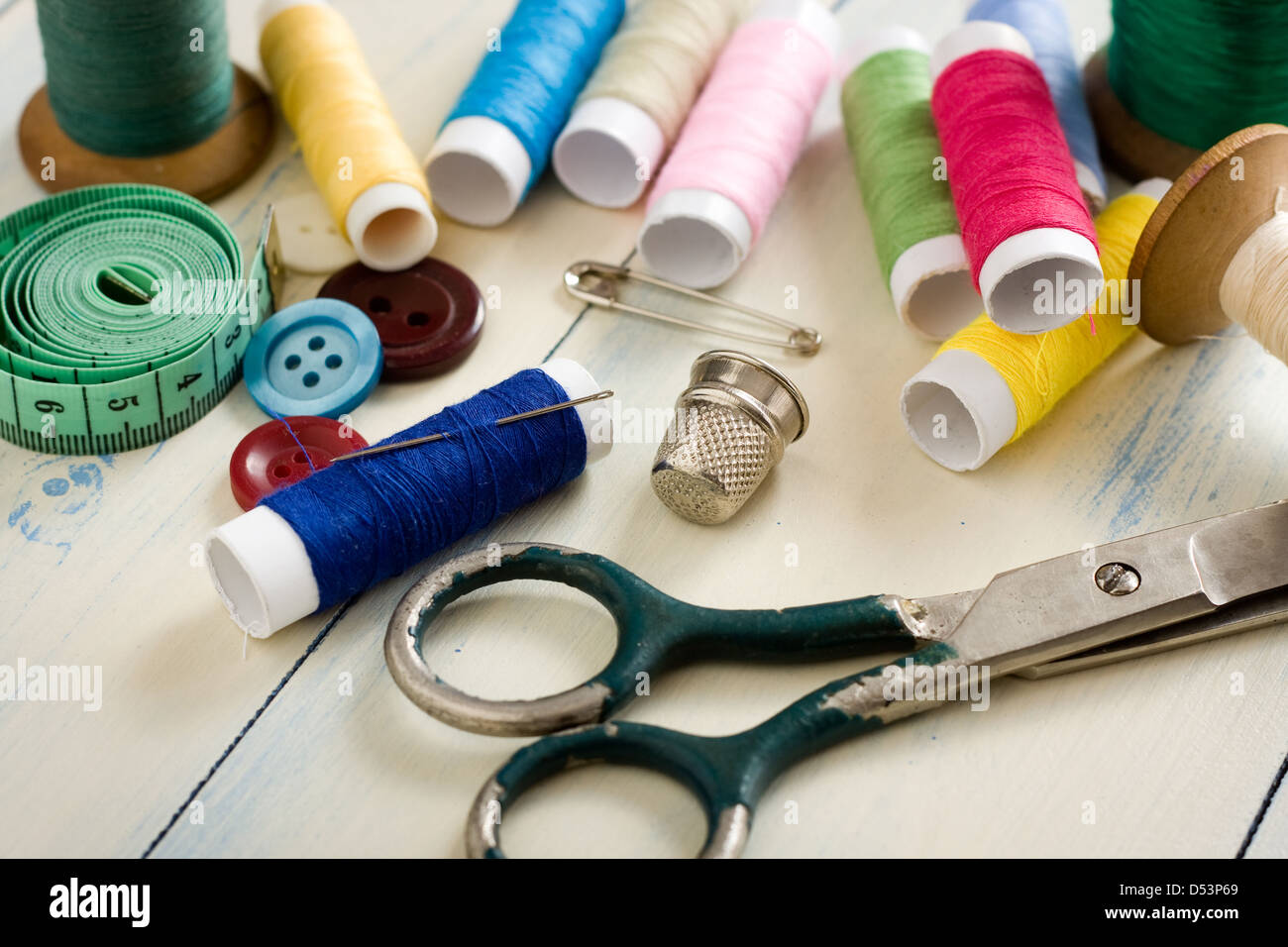 Spools of threads and buttons on old wooden table Stock Photo - Alamy