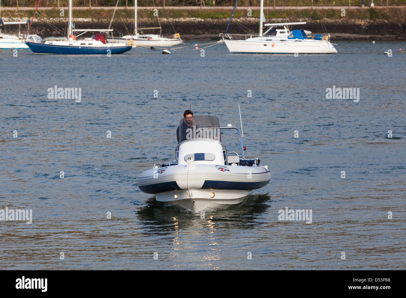 A RIB speedboat slowly approaches the shore Stock Photo - Alamy