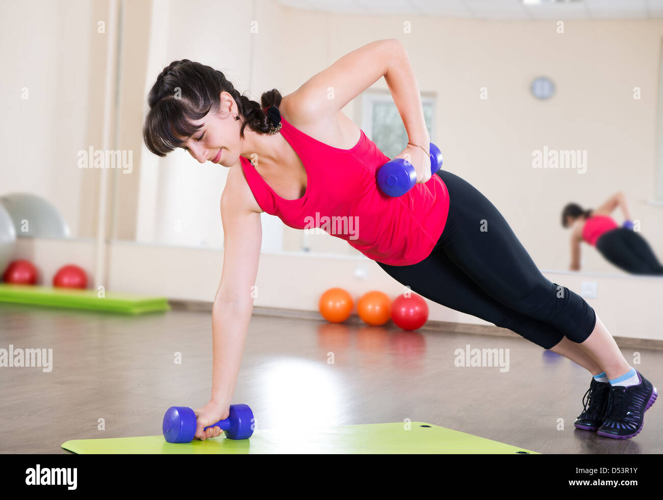 Pretty young girl fitness workout in gym Stock Photo - Alamy