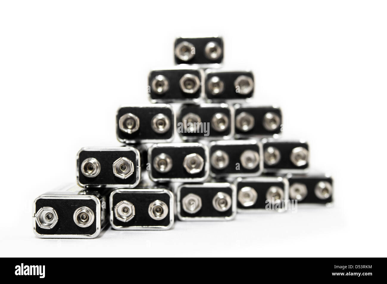 Nine volt batteries forming a pyramid, on white background. Focus on ...