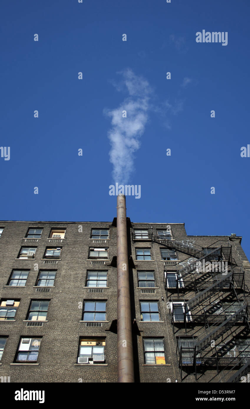 Smoking house. Smoke going out of the chimney of a brick house Stock ...