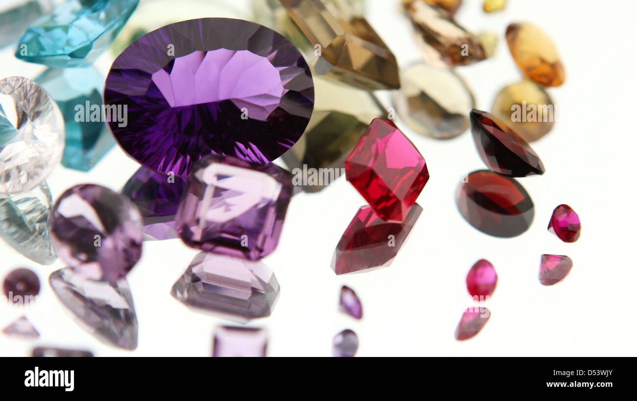 Real gemstones on mirror with reflection Stock Photo - Alamy