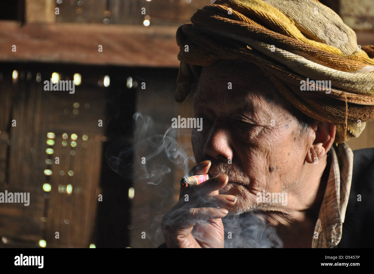 Myanmar, portrait of a mature man smoking a cigar Stock Photo - Alamy